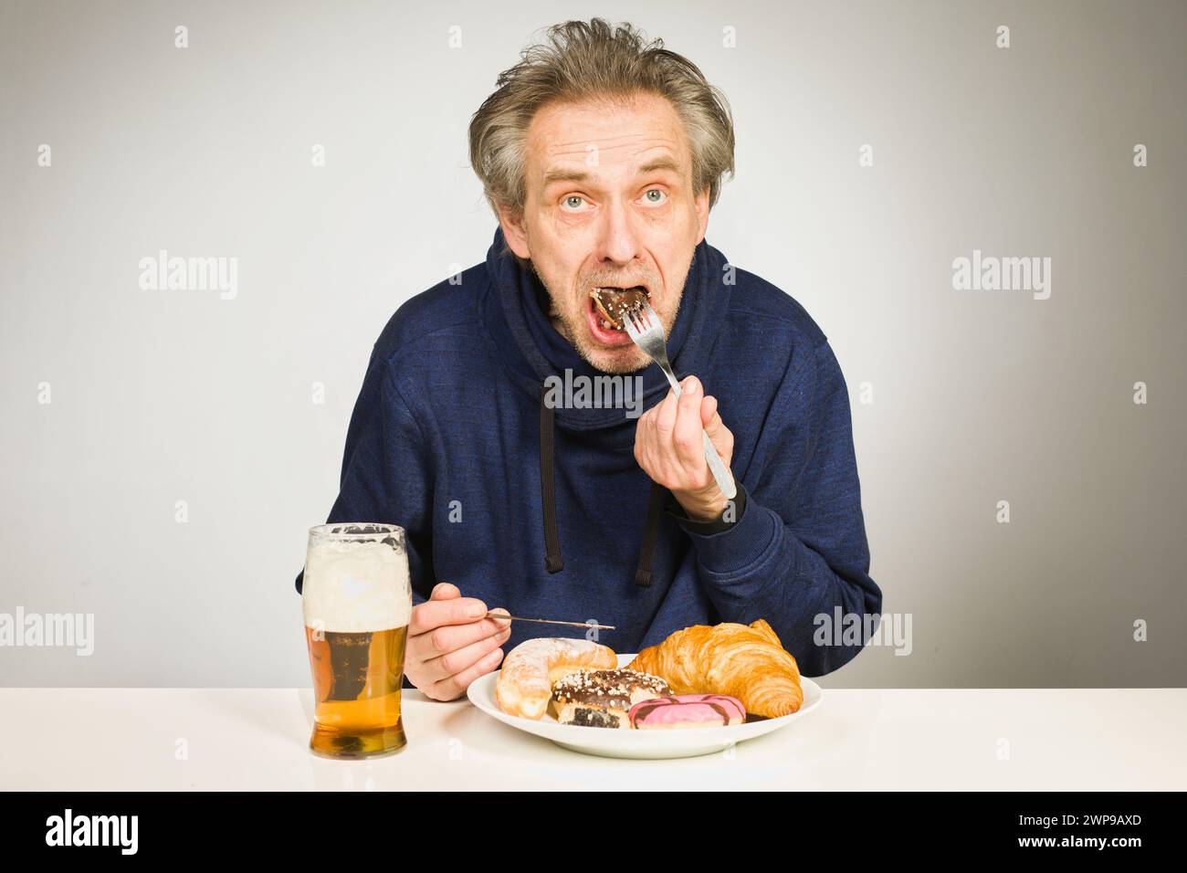 A senior man eating sweets hi-res stock photography and images - Alamy