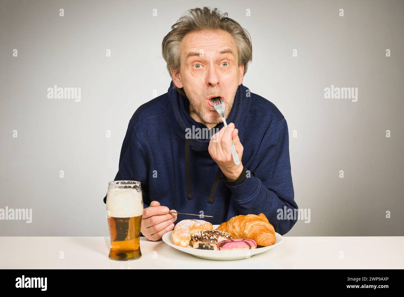 An aged man eating sweets hi-res stock photography and images - Alamy