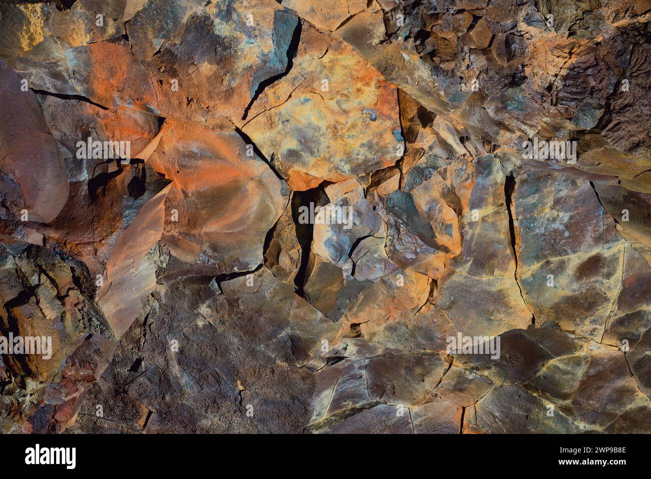 Colorful abstract mineral texture background with vibrant hues on rocky ...