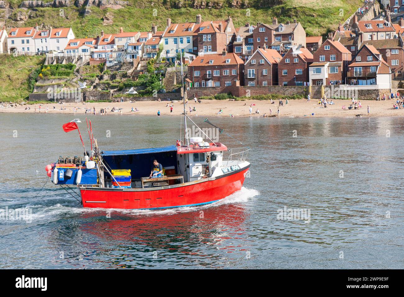 Fishing boats arriving in Whitby harbour Stock Photo - Alamy