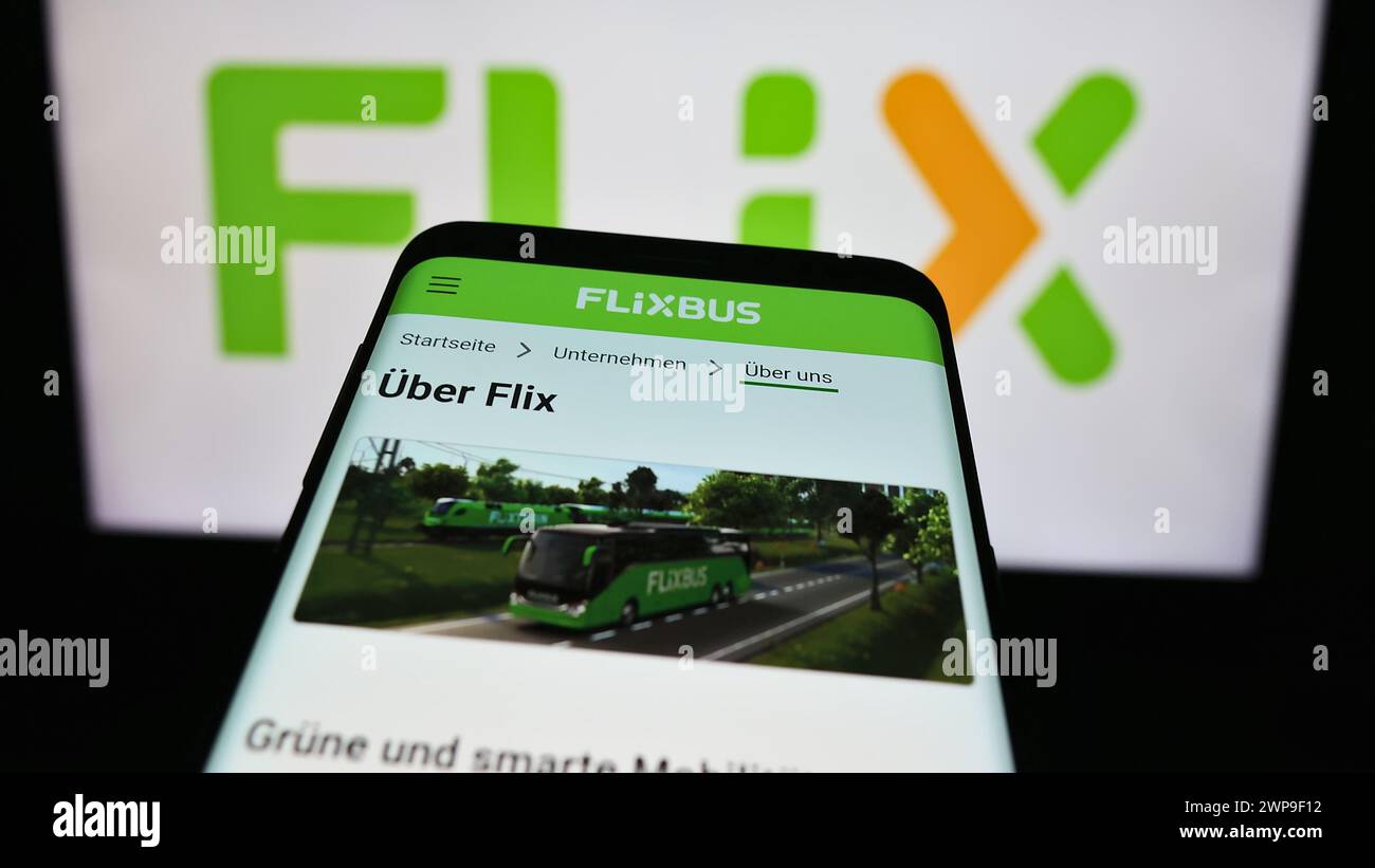 Smartphone with website of German transport company Flix SE in front of ...