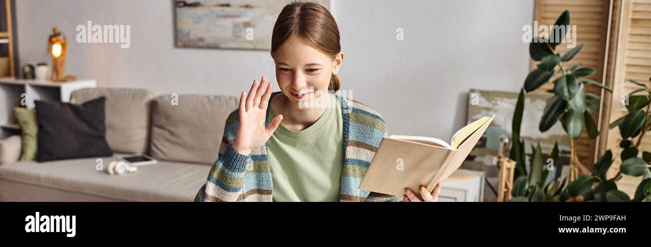 horizontal banner of happy teen girl holding book while waving hand at ...