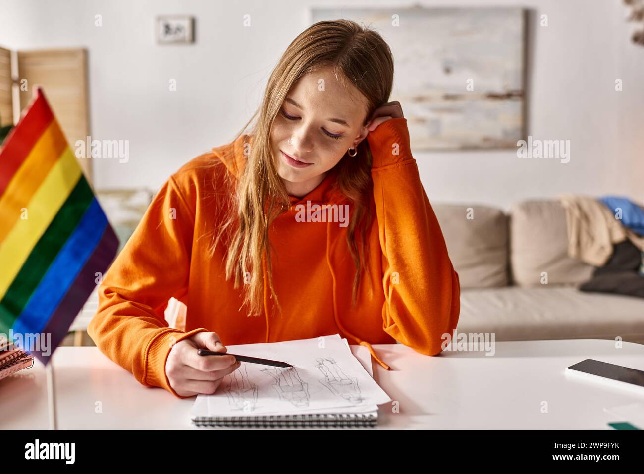 smiling teenage girl drawing a sketch, immersed in creative process ...