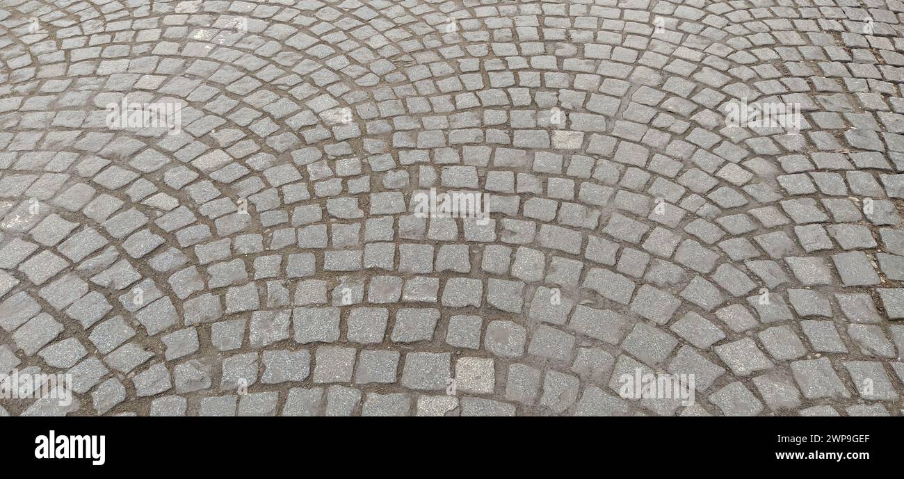 Cobblestone square in the old quarter of the city. Square and uneven stones are tiled ...
