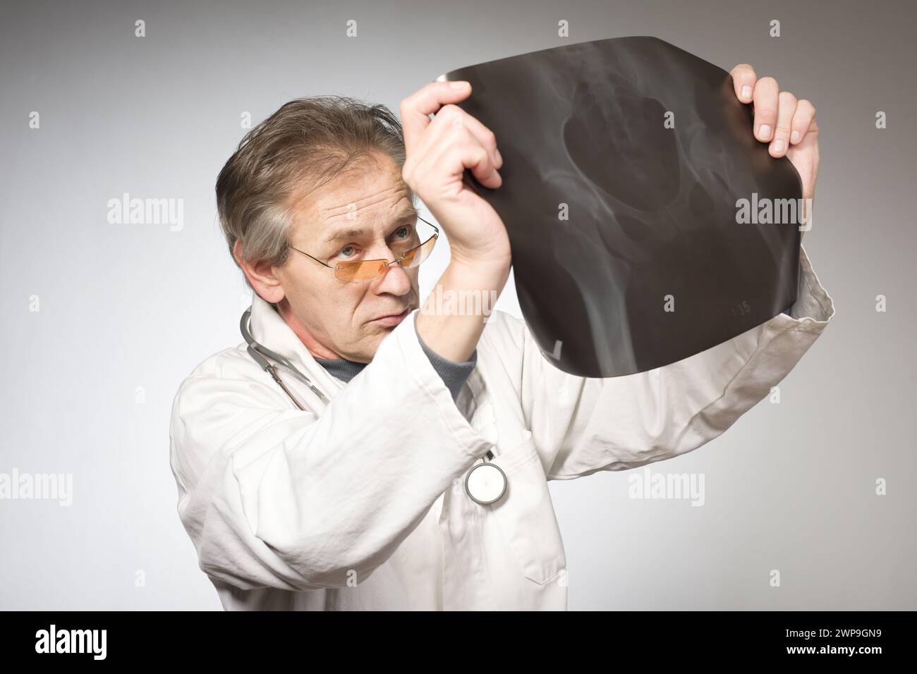 Doctor practicioner in traditional retro medical gown determining ...