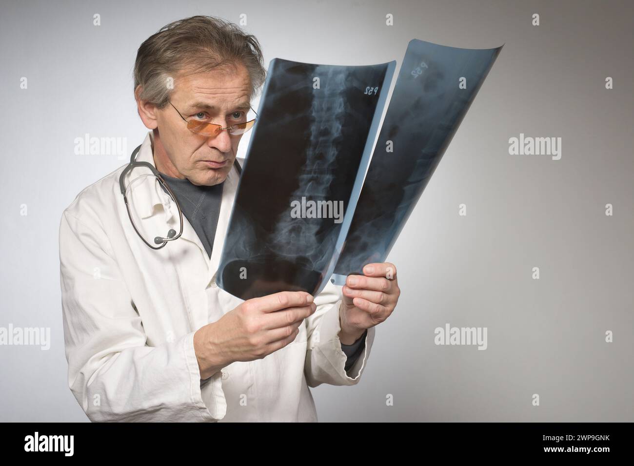 Doctor practicioner in traditional retro medical gown determining ...