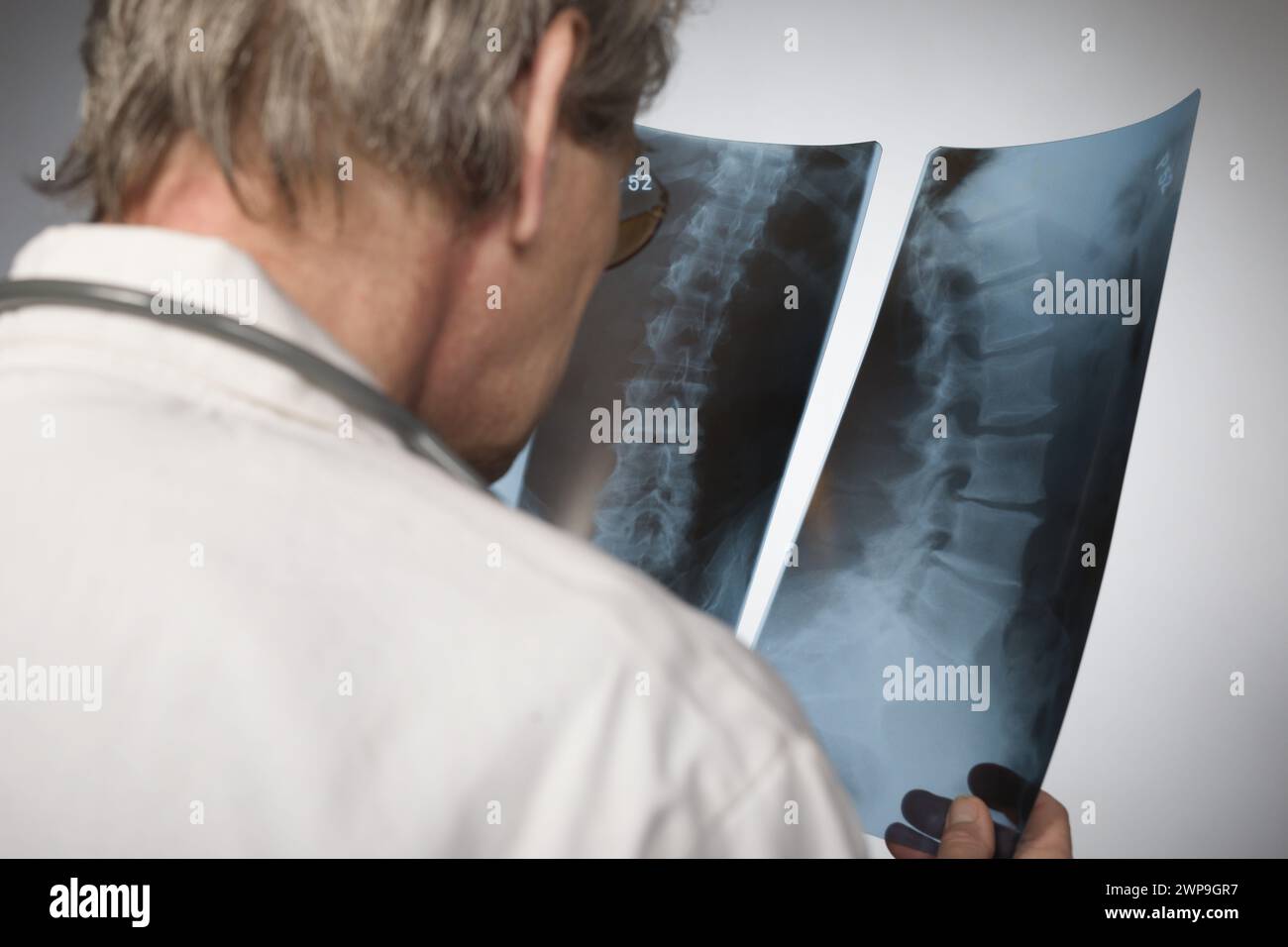 Doctor practicioner in traditional retro medical gown determining ...