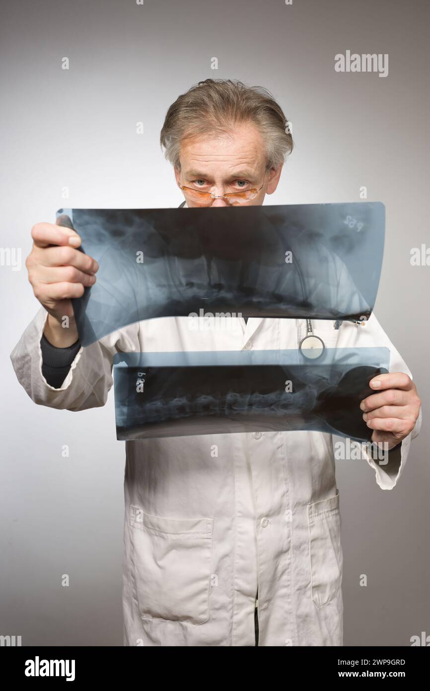 Doctor practicioner in traditional retro medical gown determining ...