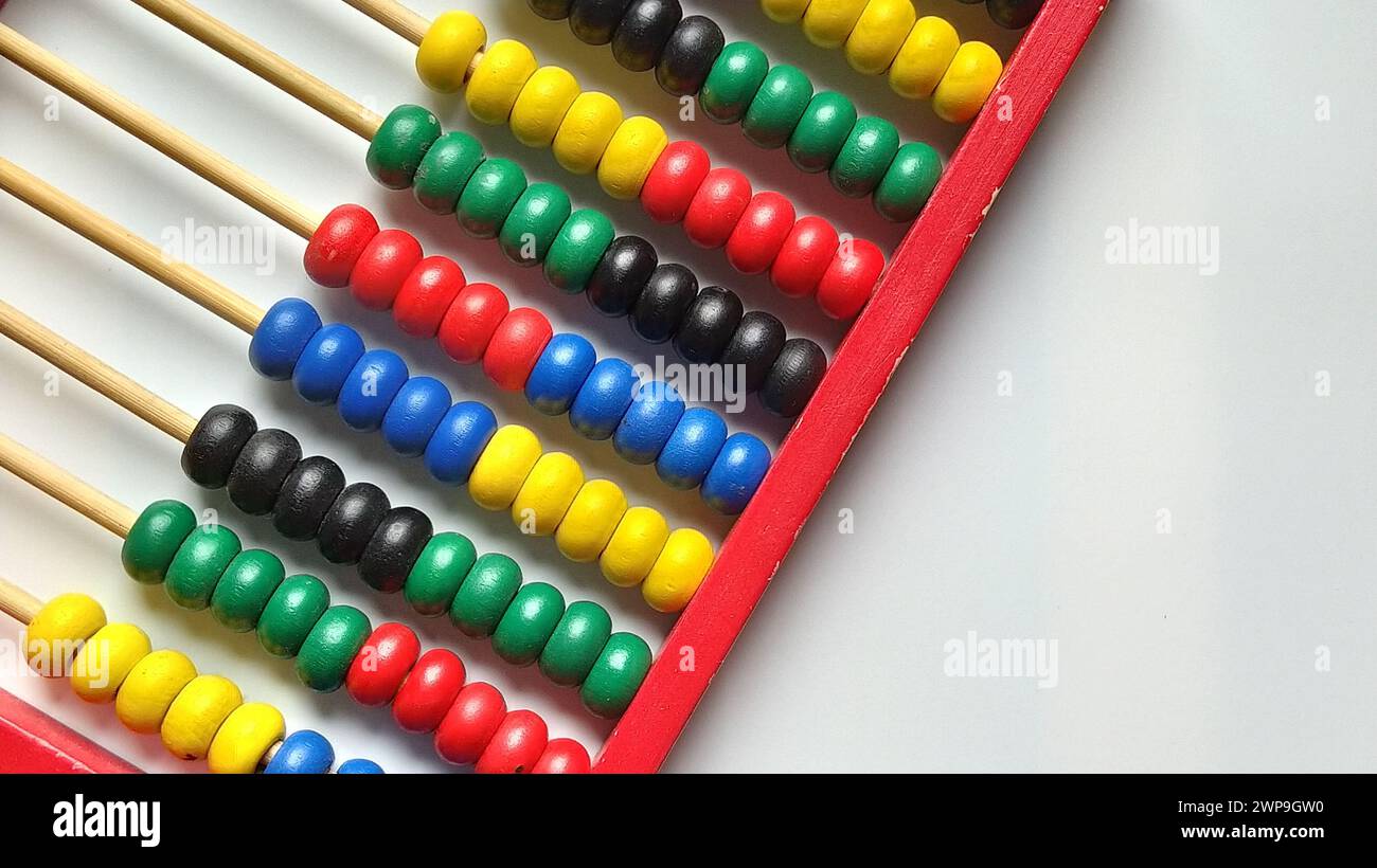Wooden abacus. Red wooden frame with cross rods. Red, blue, yellow ...