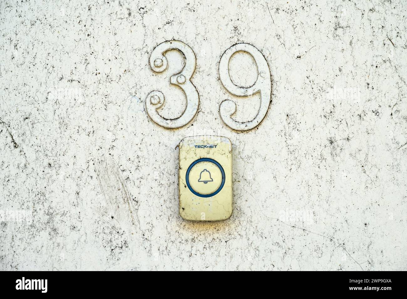 Number 39 and a doorbell on an old worn out front door Stock Photo - Alamy