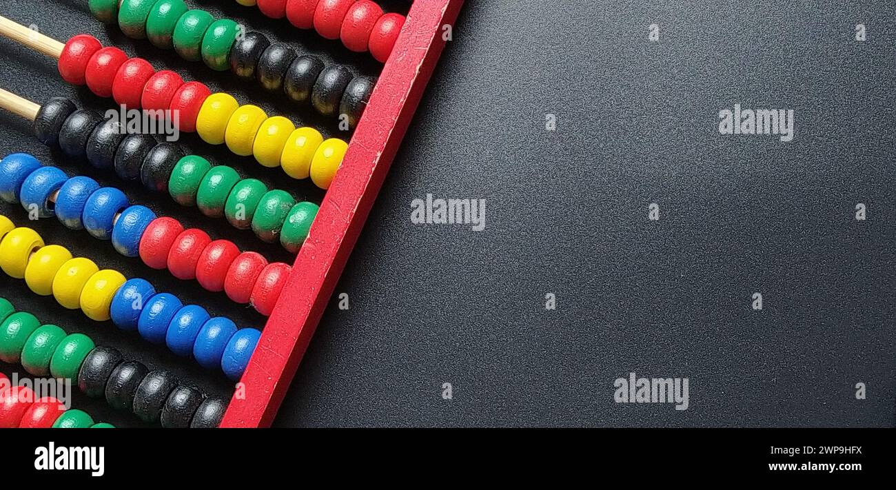 Wooden abacus. Red wooden frame with cross rods. Red, blue, yellow ...