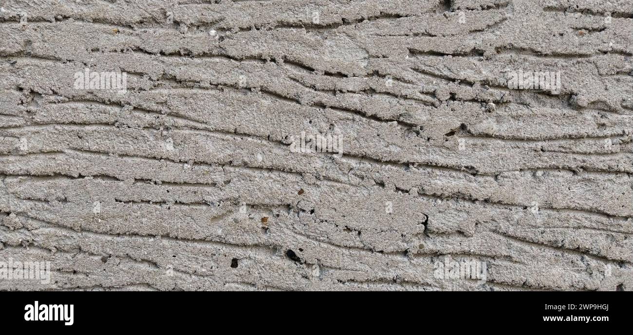 Light and shadow. Wall of the house with a self-made plastered facade ...
