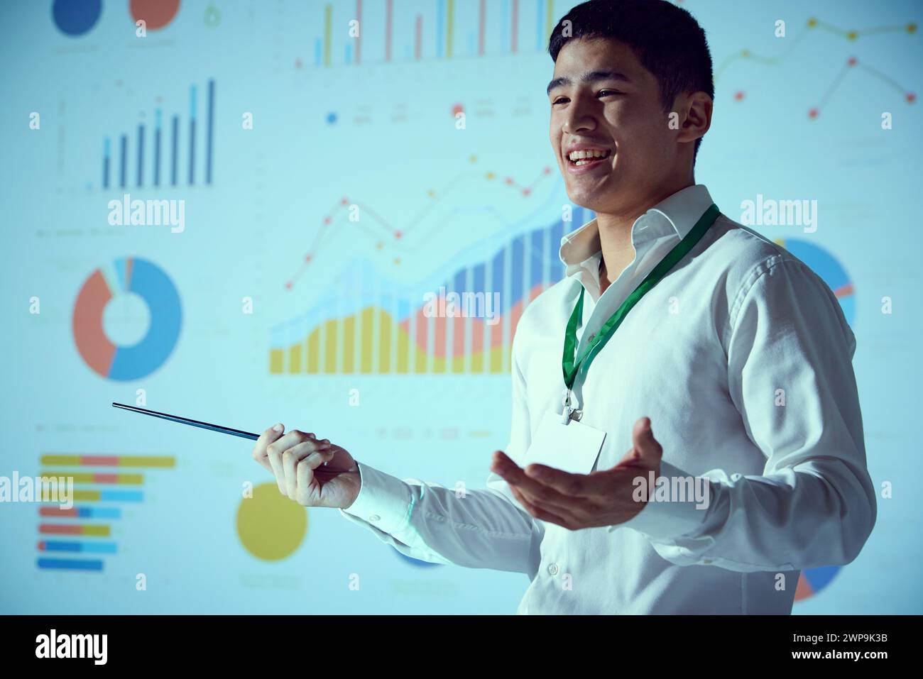 Asian businessman, speaker delivering presentation to attentive crowd ... Asian businessman, speaker delivering presentation to attentive crowd ...