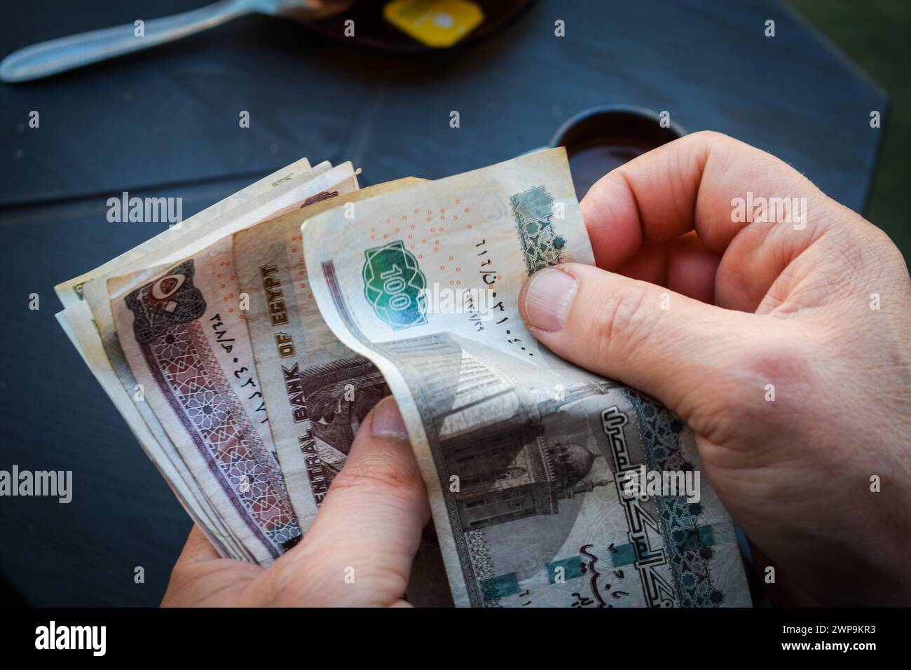 Cairo, Egypt, 6 March 2024. A man counts Egyptian pound banknotes at a ...