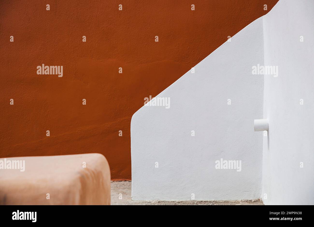 A striking contrast of earthy red and crisp white walls, showcasing the ...