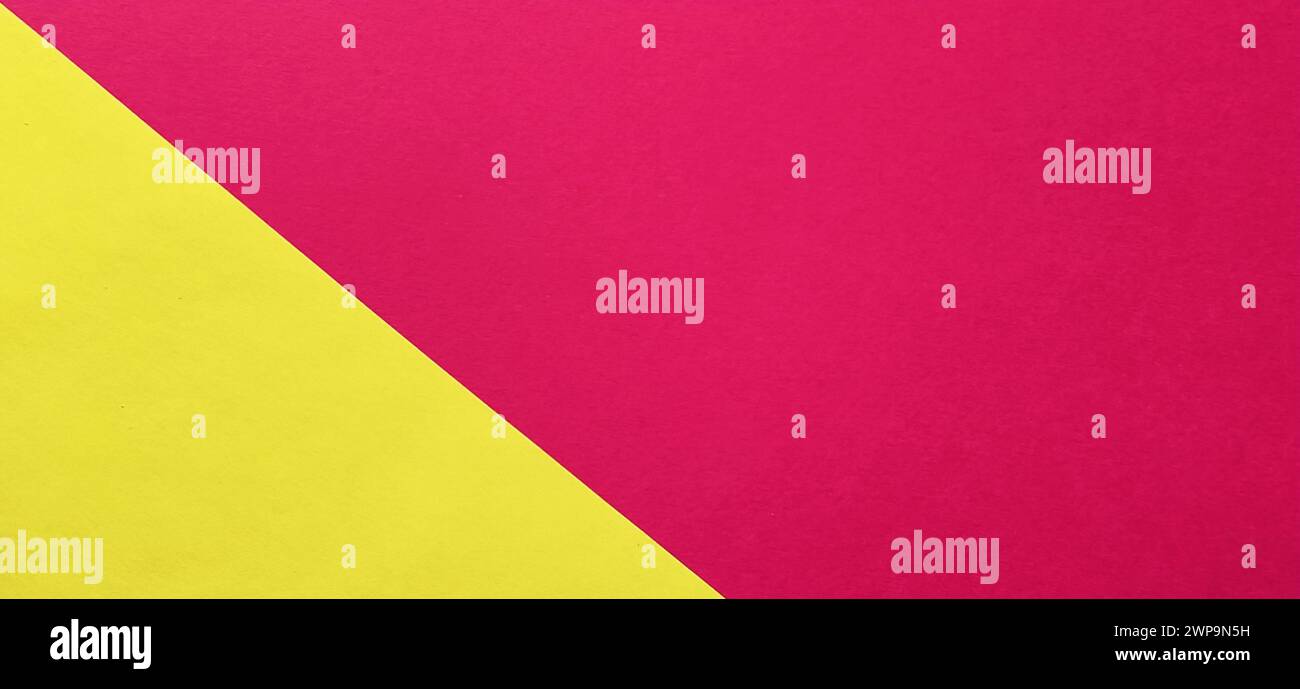 A yellow sheet of paper is laid sideways on a red sheet of paper. Thick ...