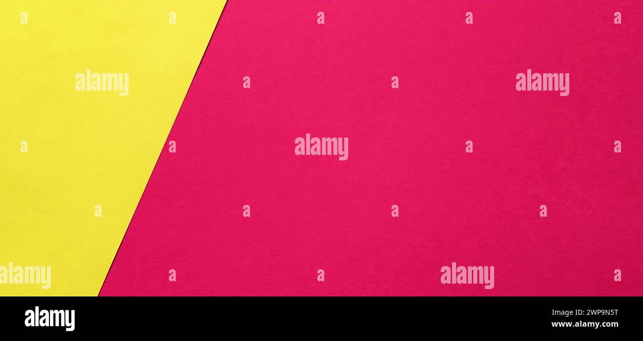 A yellow sheet of paper is laid sideways on a red sheet of paper. Thick ...