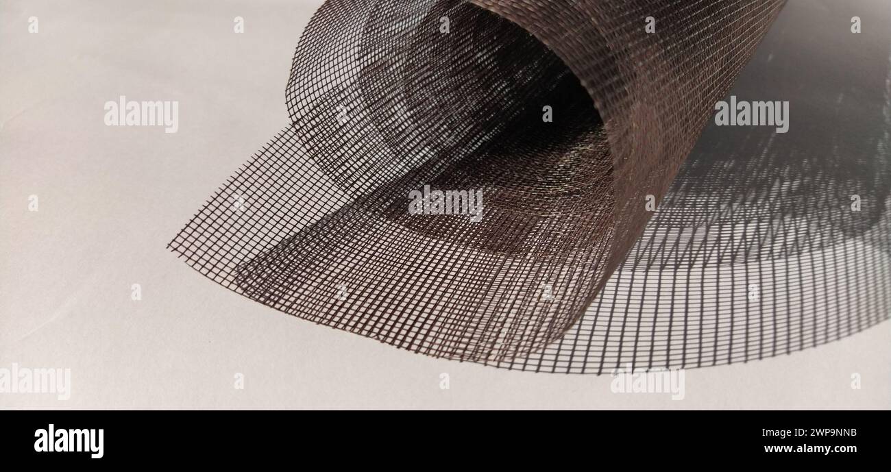 Roll of window screen, closeup. Roll of brown mosquito nets. Barrage ...