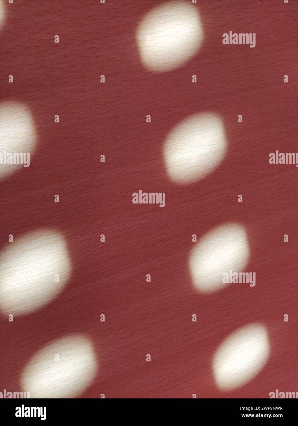 Red background with polka dots. Rays of the sun shining through the ...