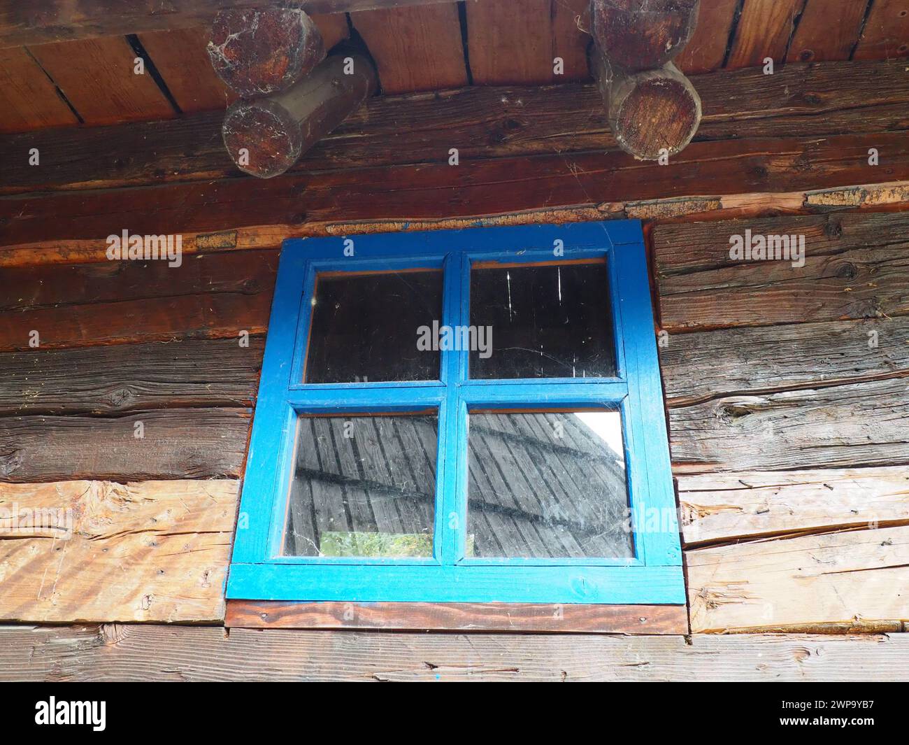 Ethno window with a blue wooden frame. Vintage house exterior ...