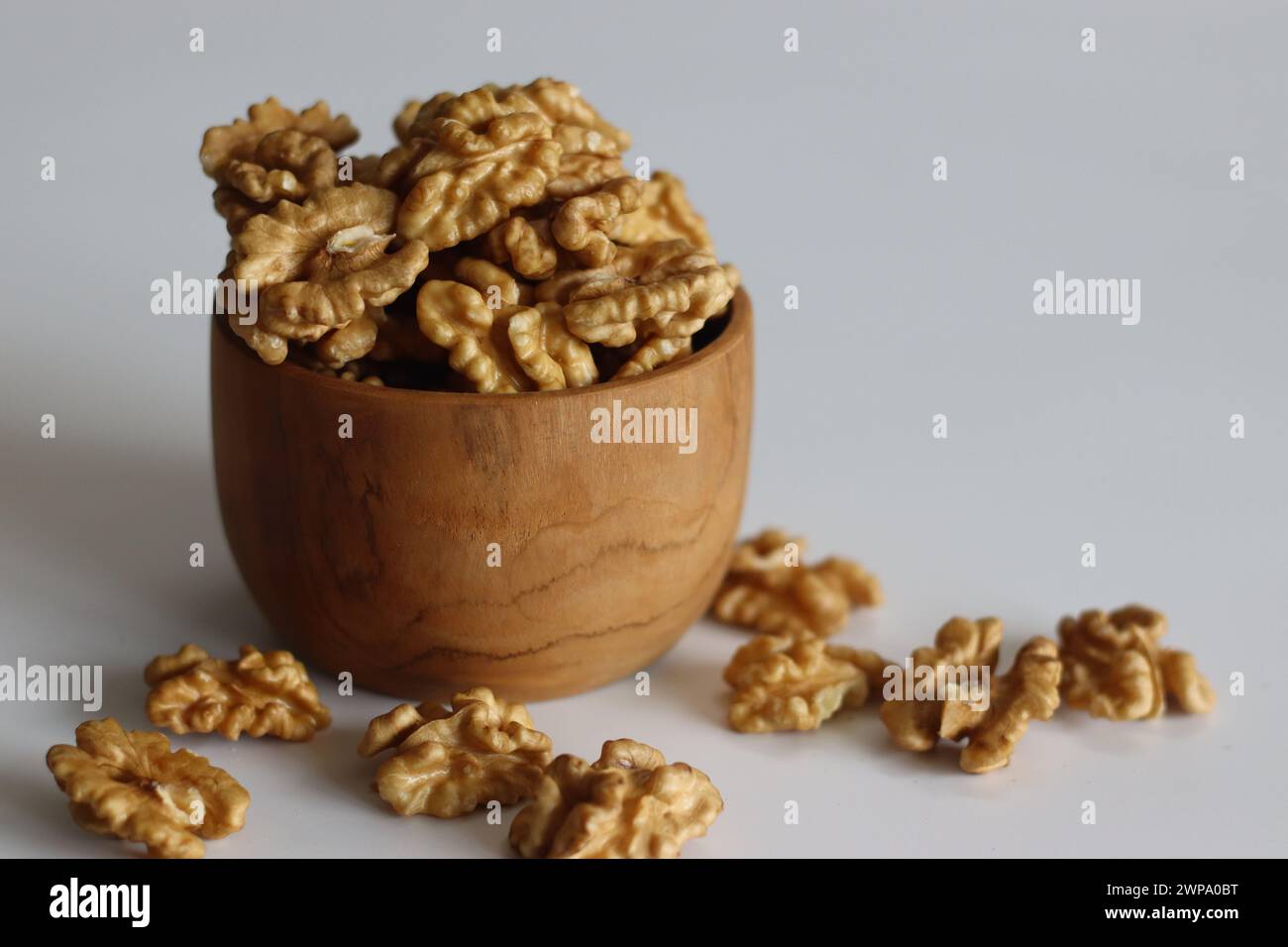 Pristine pile of premium dry walnuts in a wooden bowl, ideal for ...