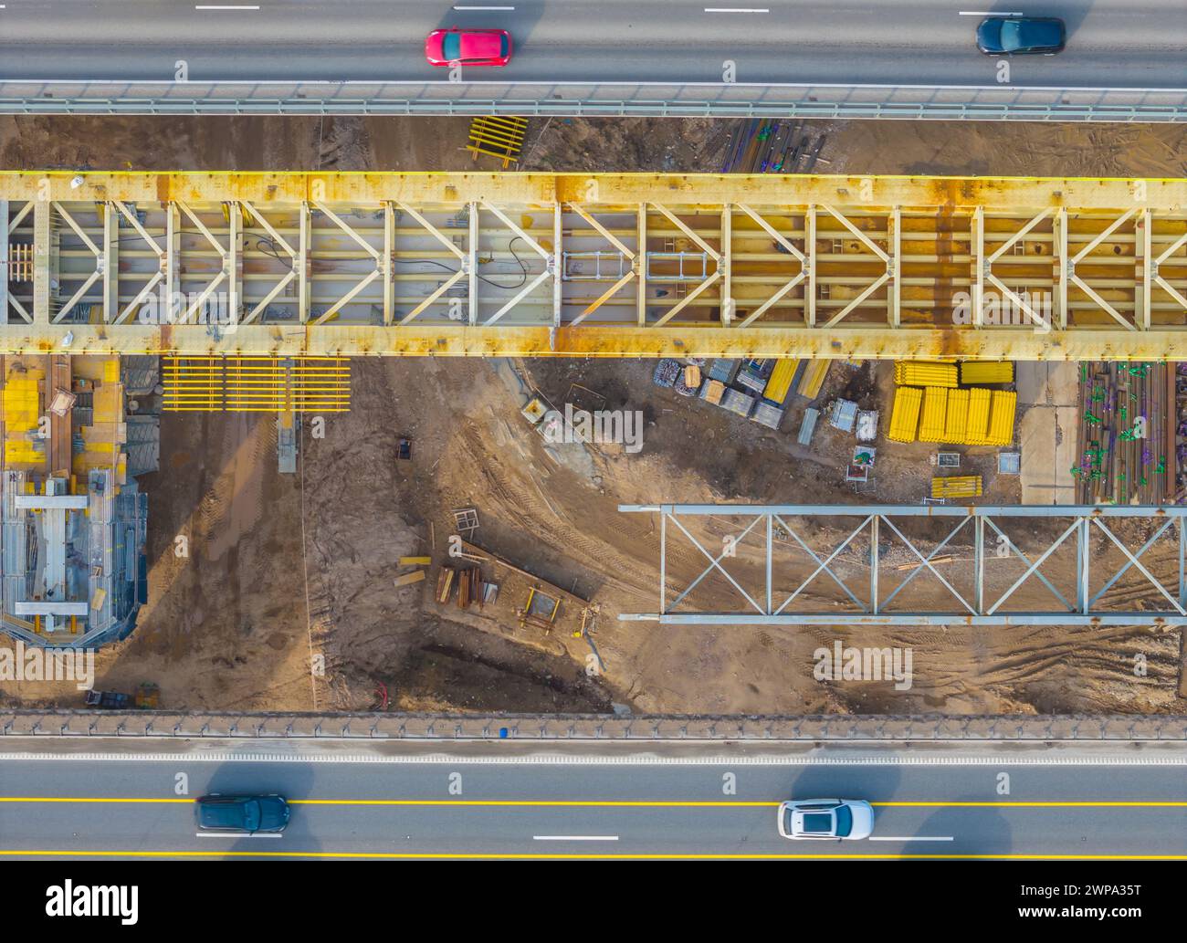 Highway road construction site. Aerial drone top view of road currently under construction ...