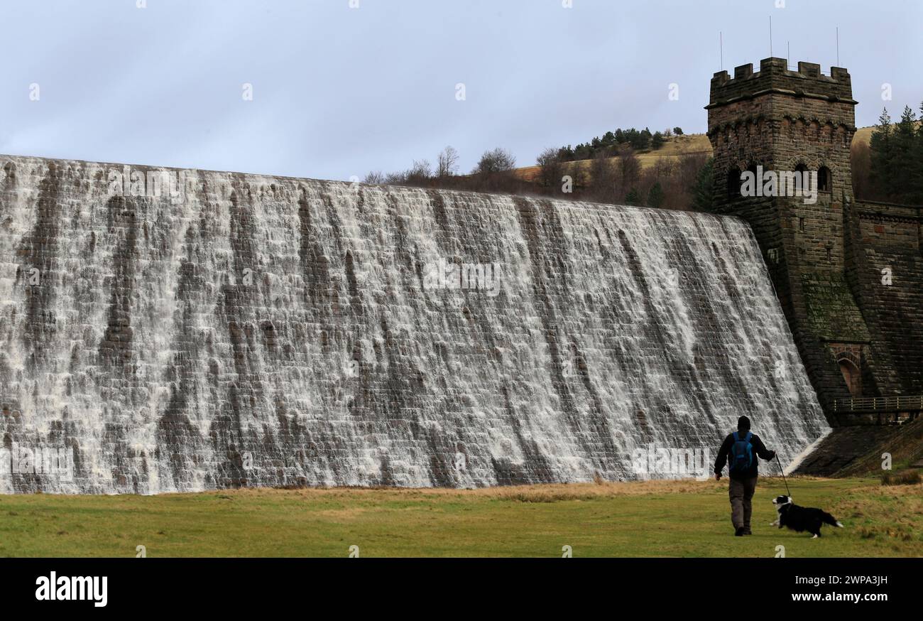 07/01/2014 After days of heavy rain, walkers are dwarfed by a wall of ...
