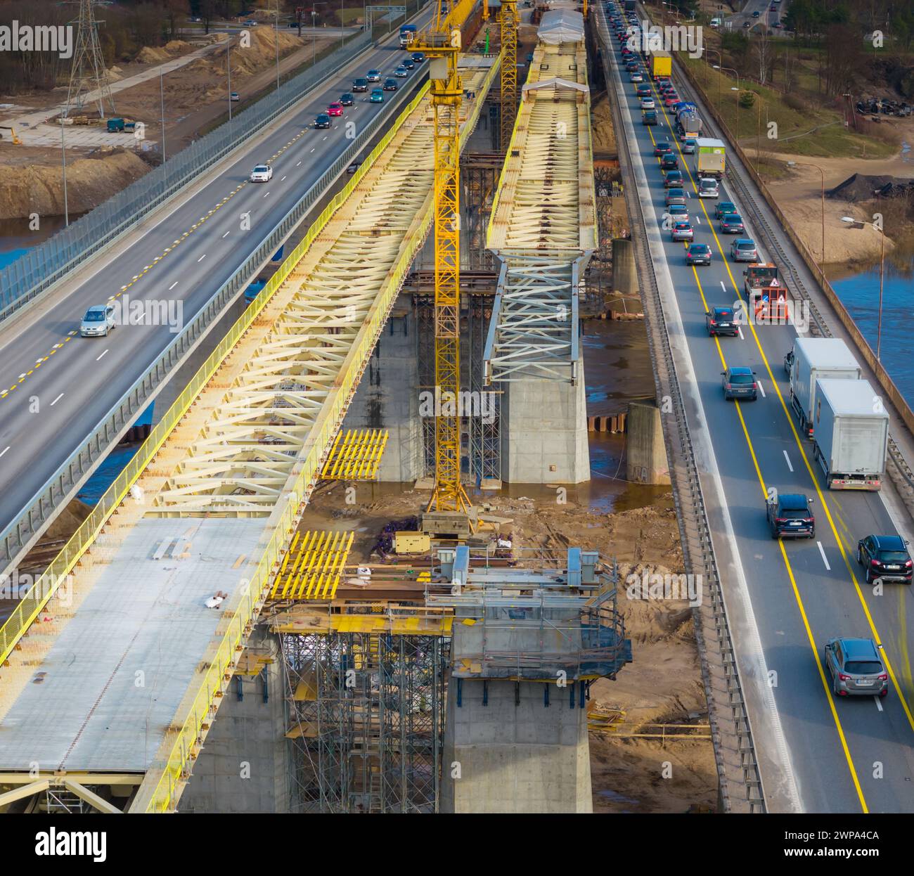 Highway road construction site. Aerial drone top view of road currently under construction ...