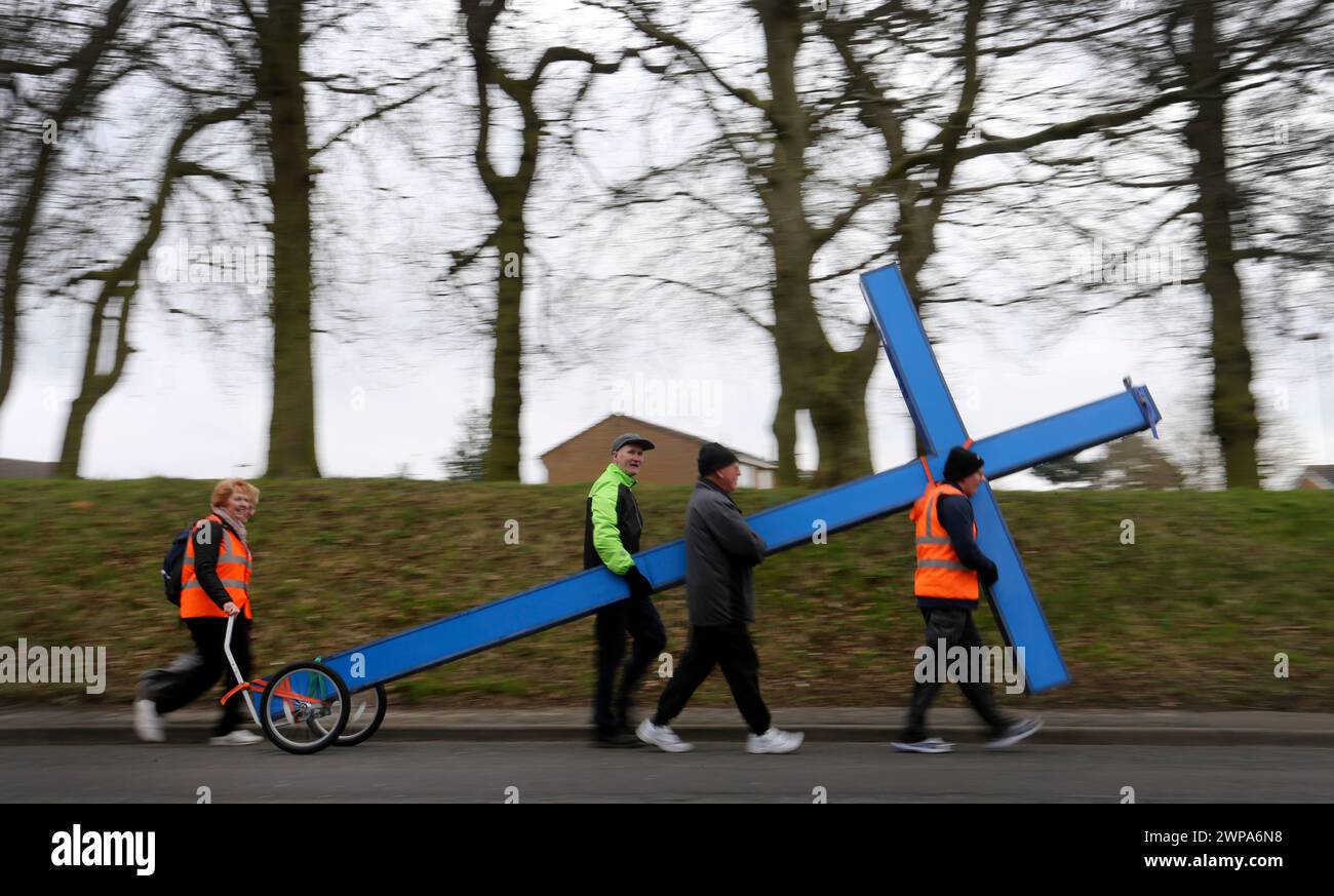 08/03/14 To mark Lent worshippers drag an 18 ft cross over 18 miles ...