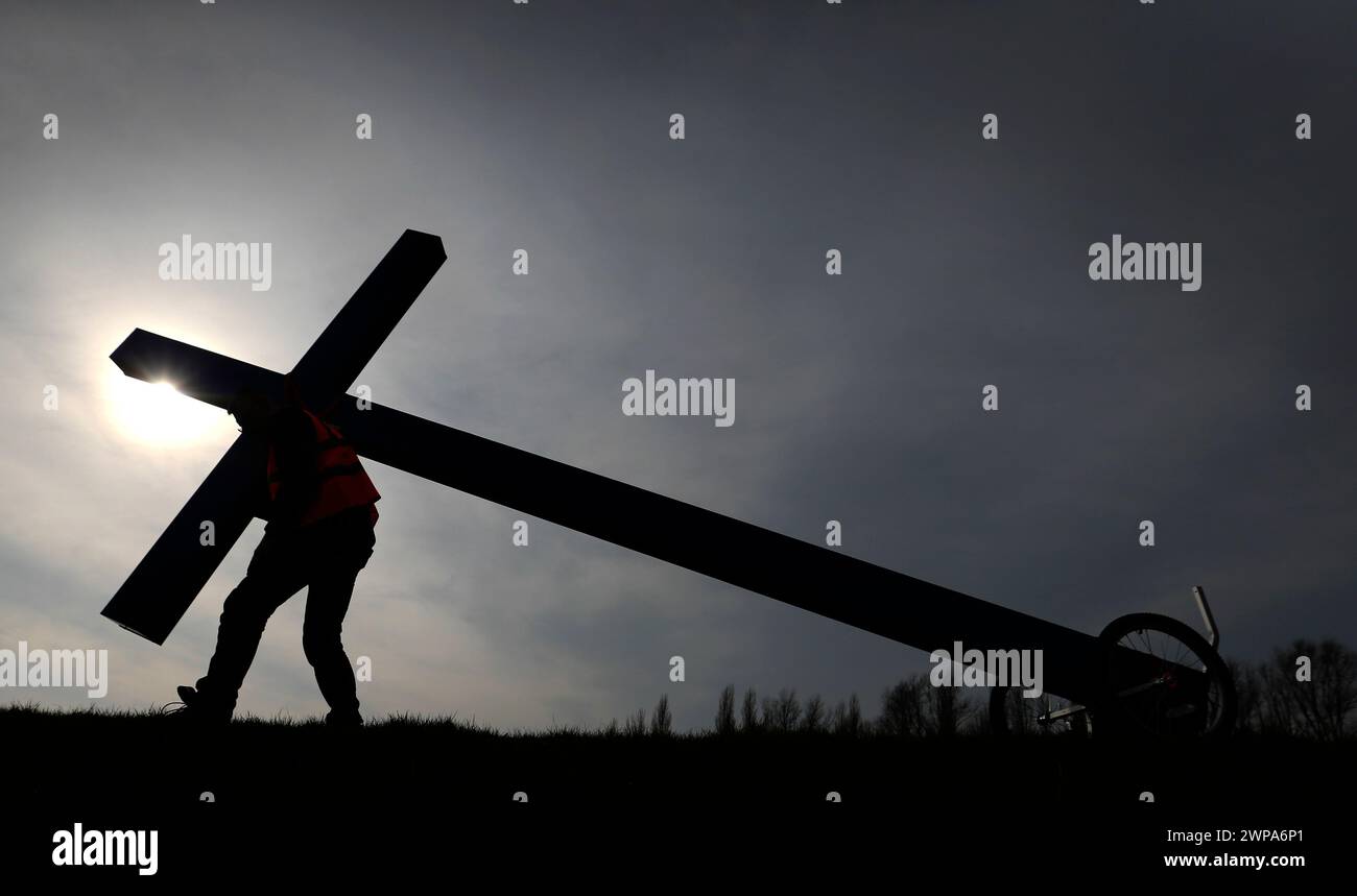08/03/14 To mark Lent worshippers drag an 18 ft cross over 18 miles ...