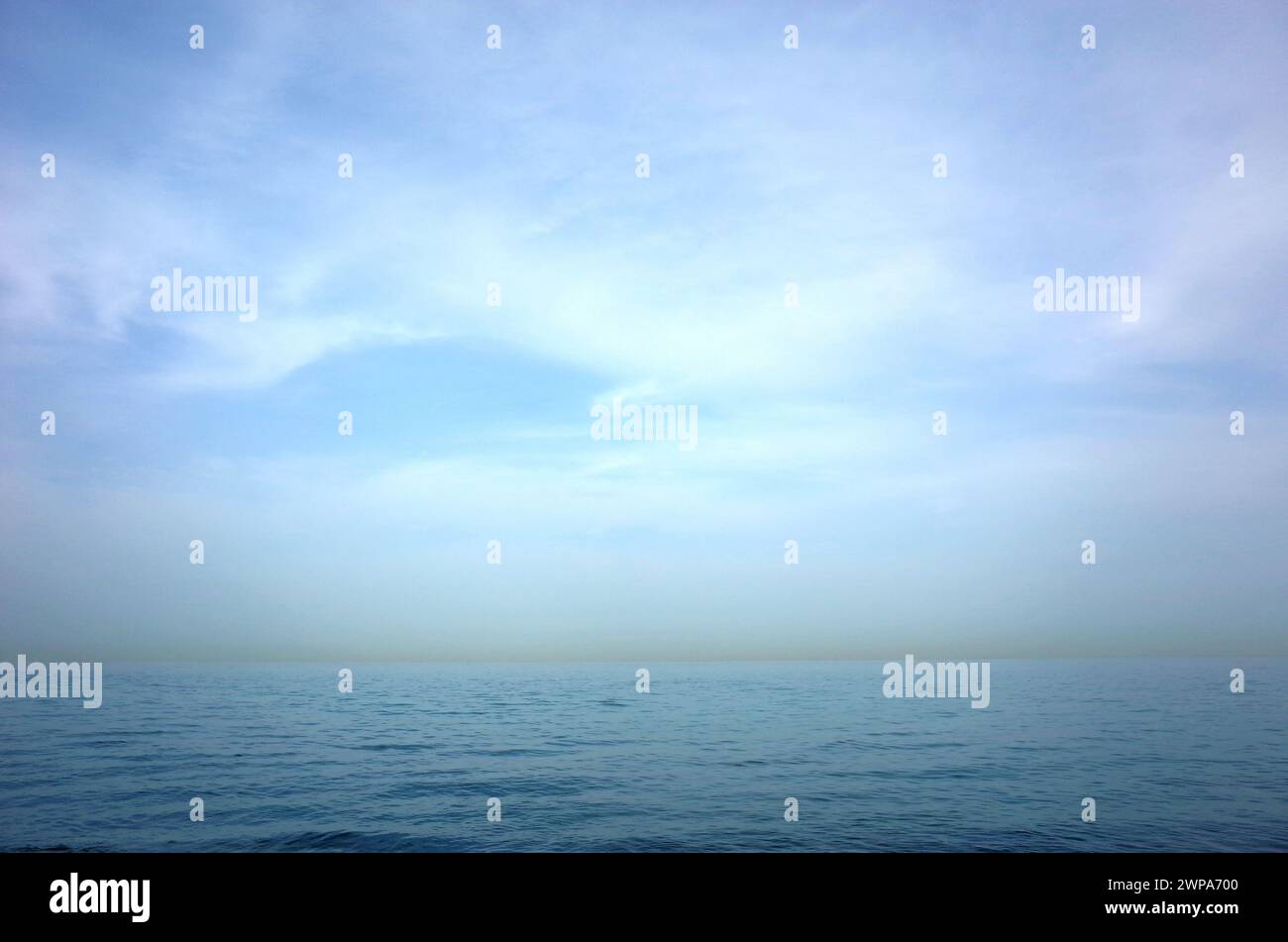 Blue seascape of Gulf of Oman seen from Arabian peninsula with yellow ...