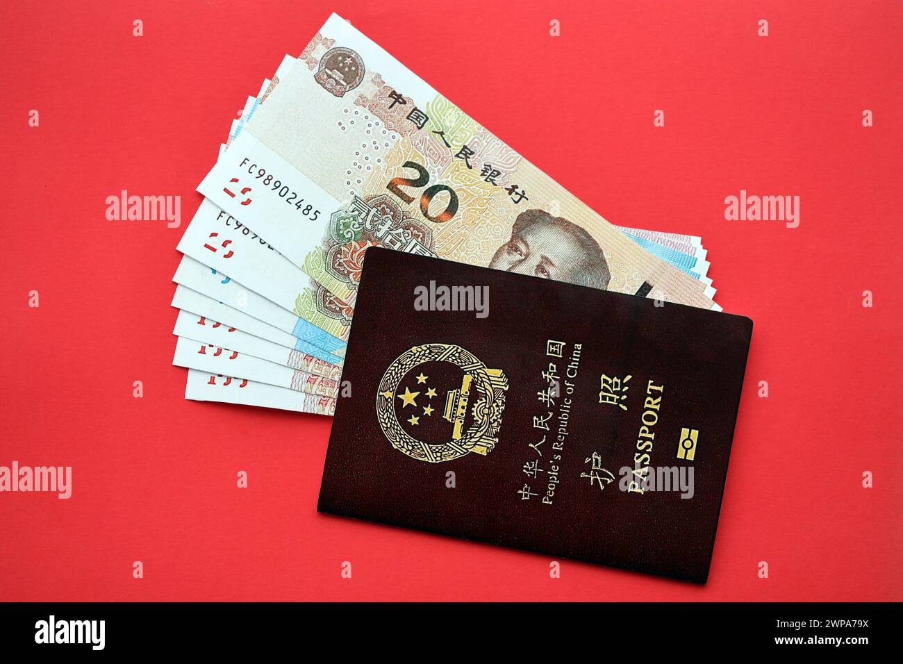 Red passport of People Republic of China and chinese yuan money bills ...