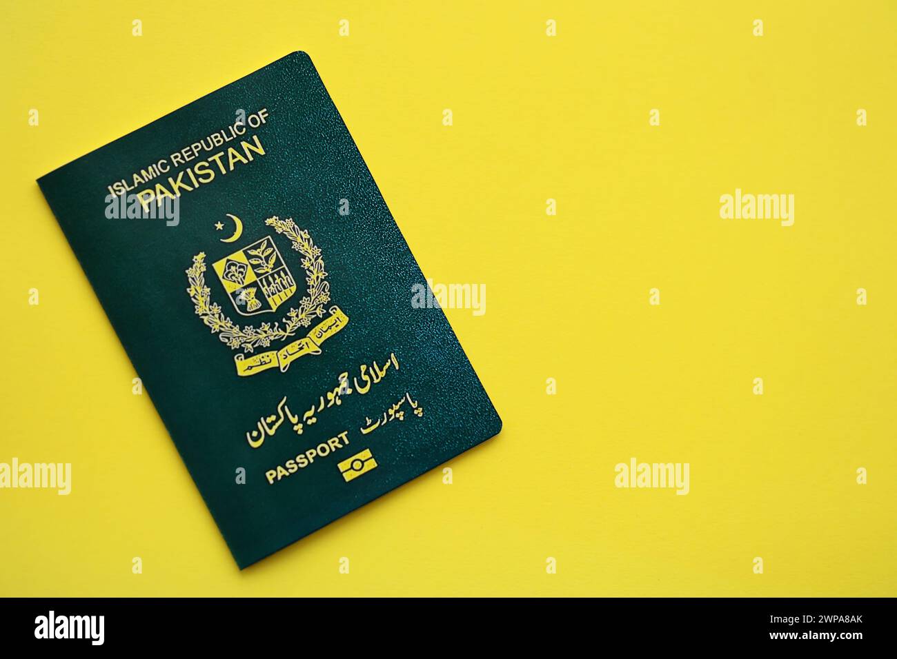 Green Islamic Republic of Pakistan passport on yellow background close ...