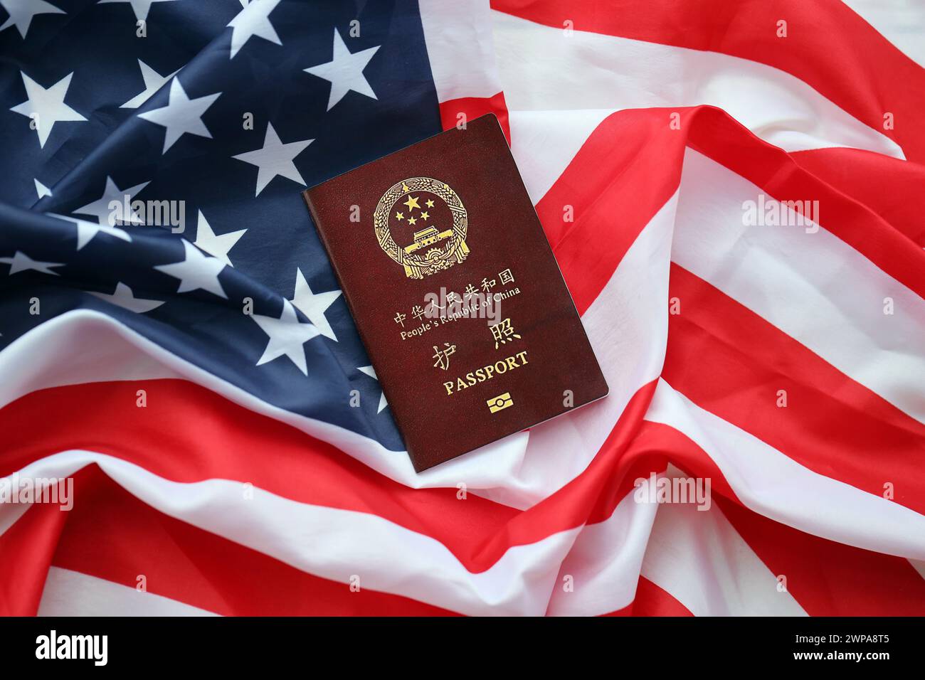 Red passport of People Republic of China on United States flag. PRC ...