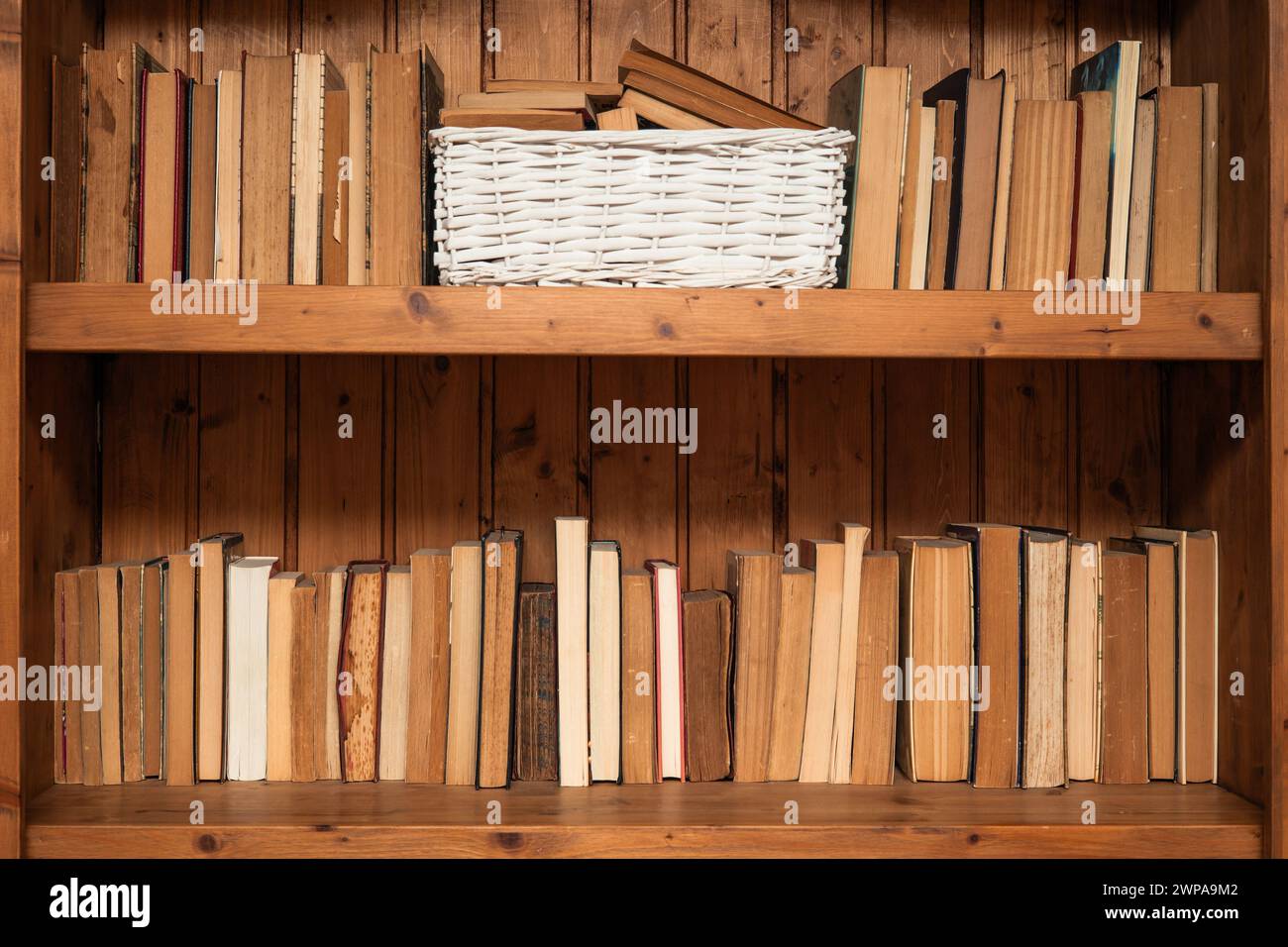 old library bookcase full of vintage books with white wicker basket ...