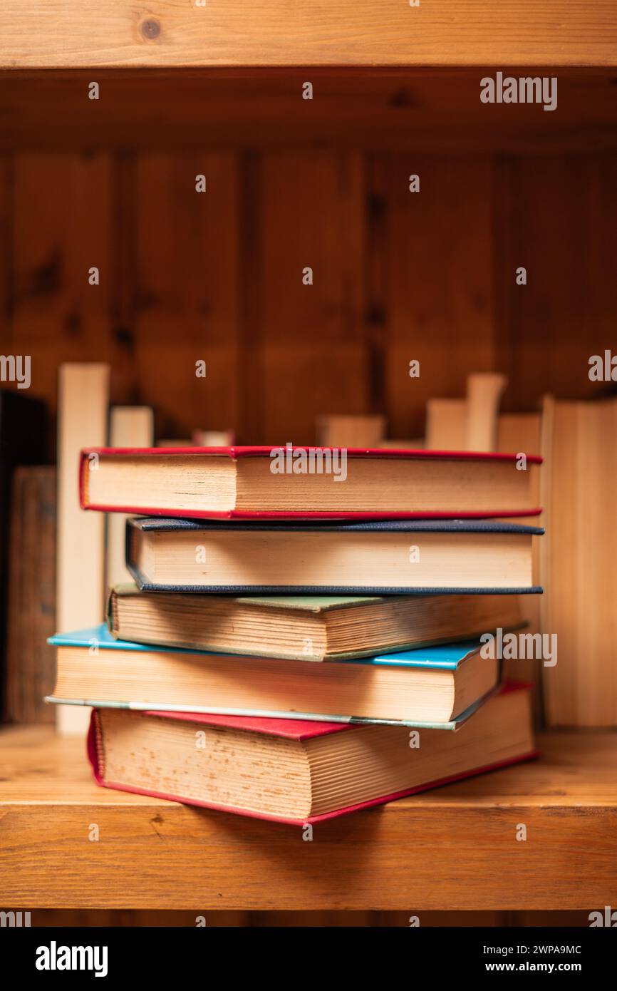 vertical portrait several textbooks stacked in the book store world ...