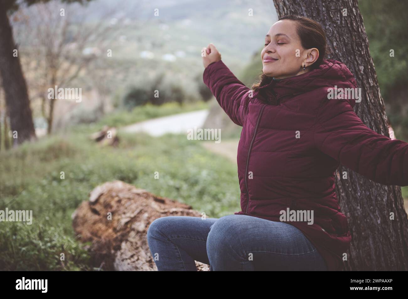 Happy young woman with closed eyes, enjoying a weekend outdoor ...