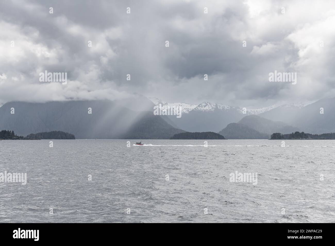 Rod and line fishing Boat with God's rays and rain in the mountains ...