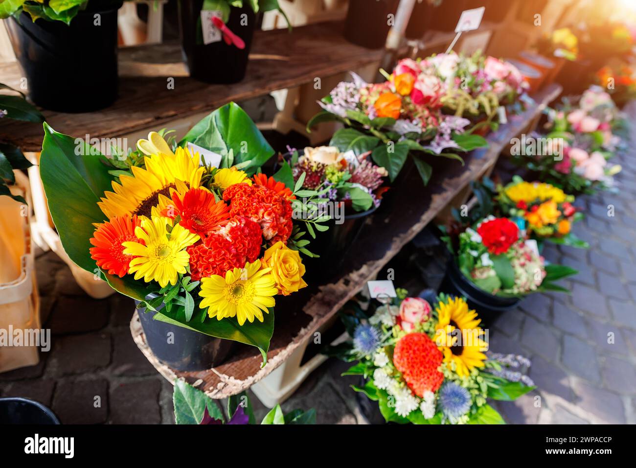Many colorful array of fresh flower bouquets on display at an outdoor ...