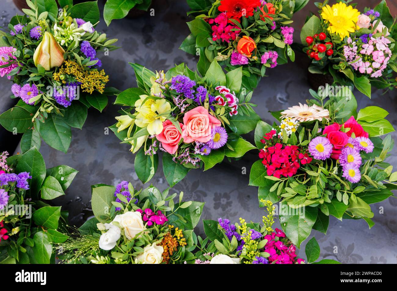 Many colorful array of fresh flower bouquets on display at an outdoor ...