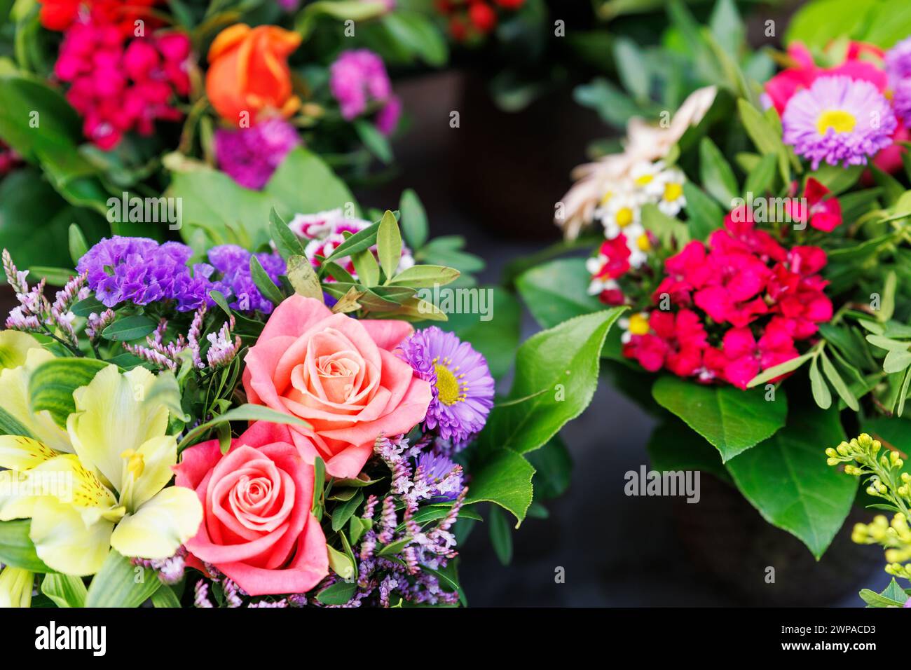 Many colorful array of fresh flower bouquets on display at an outdoor ...