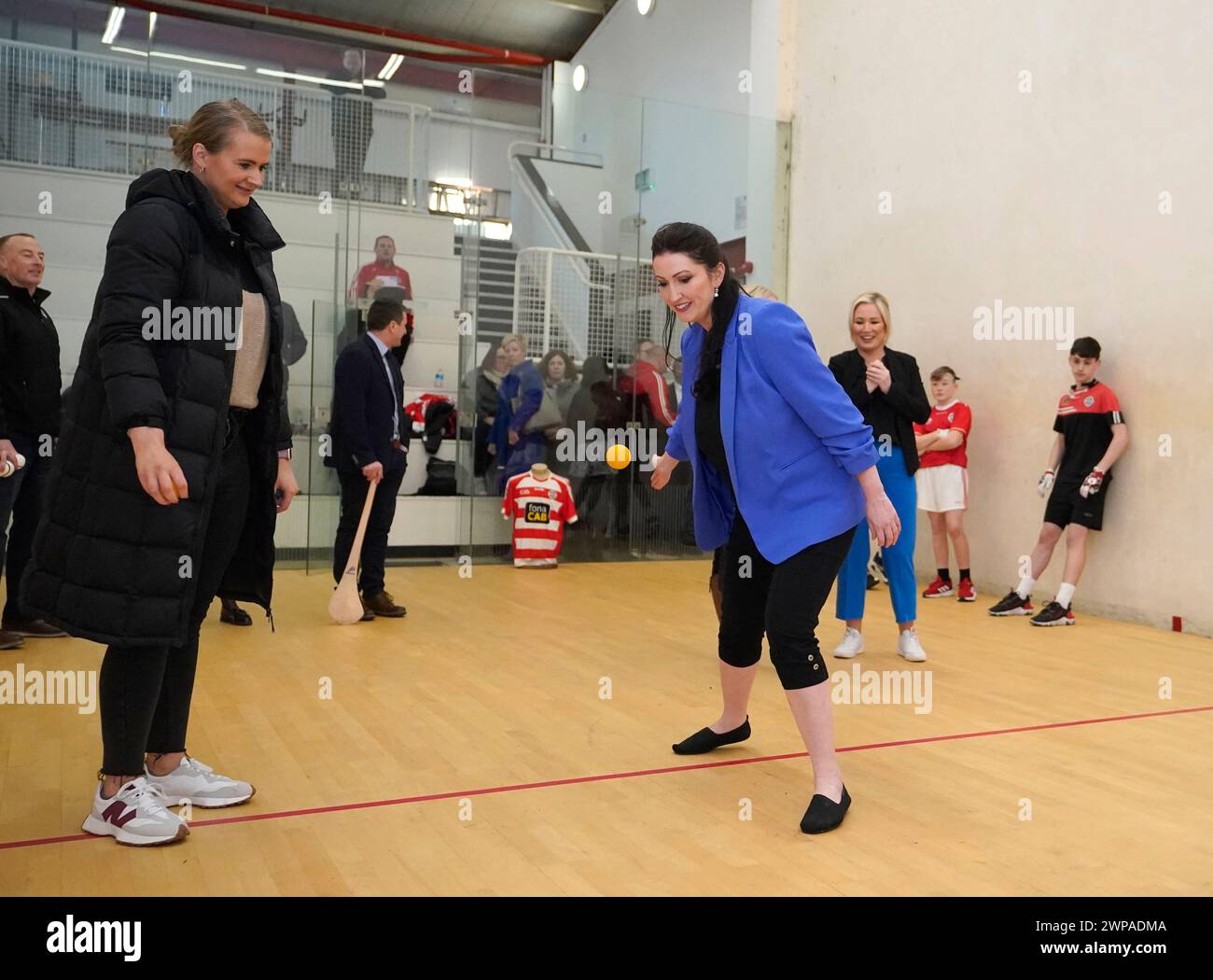 Deputy First Minister Emma Little-Pengelly (centre) tries handball ...