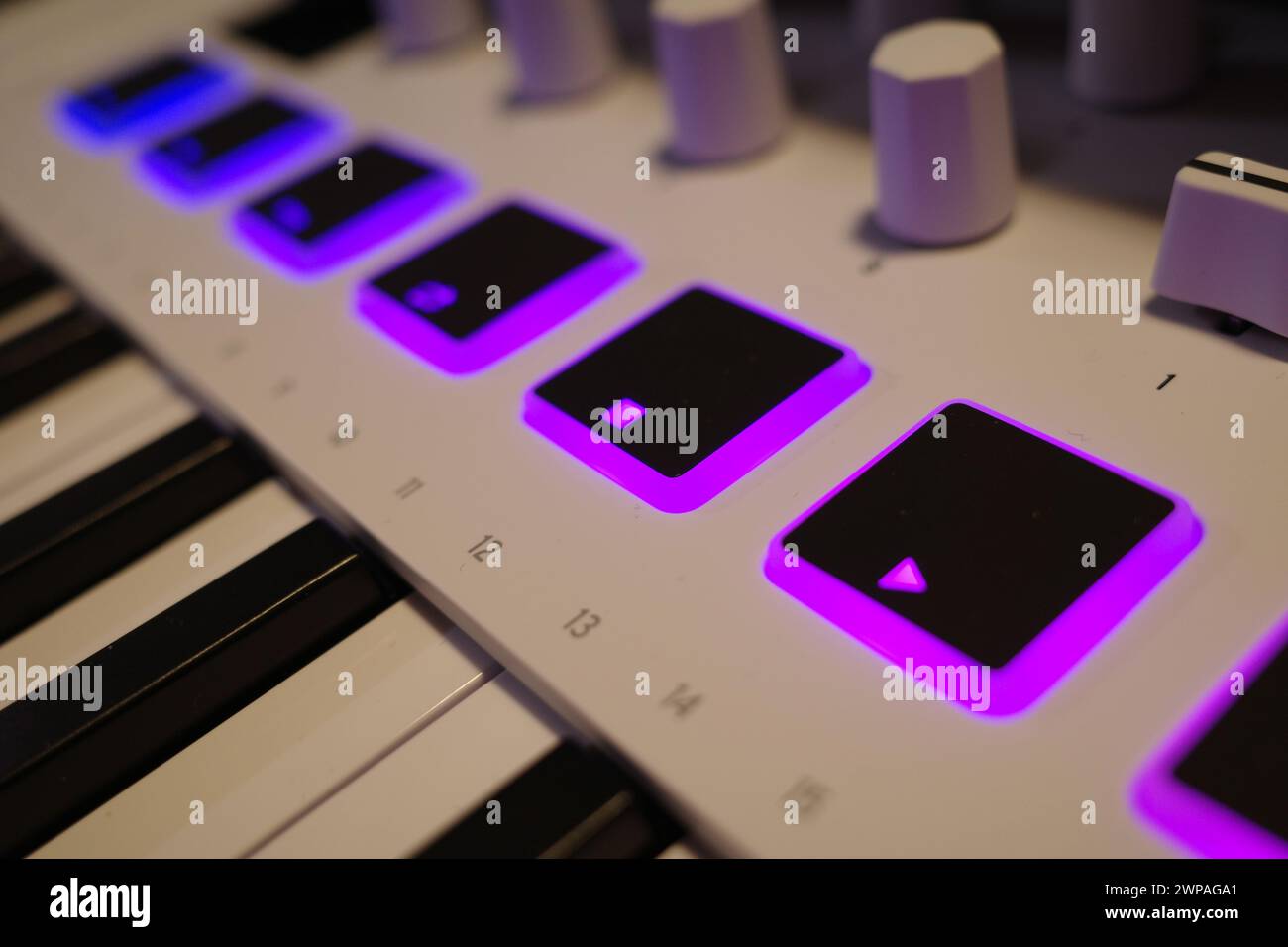Detail of a modern mini synthesizer with purple glowing buttons Stock ...