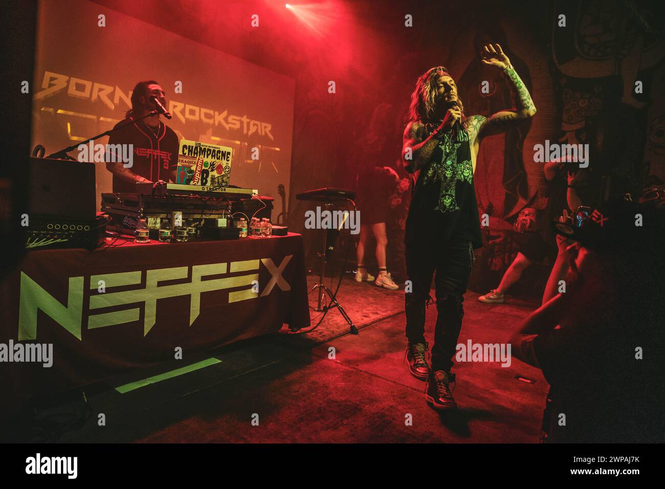 Audience watching two female singers performing on stage at a concert ...