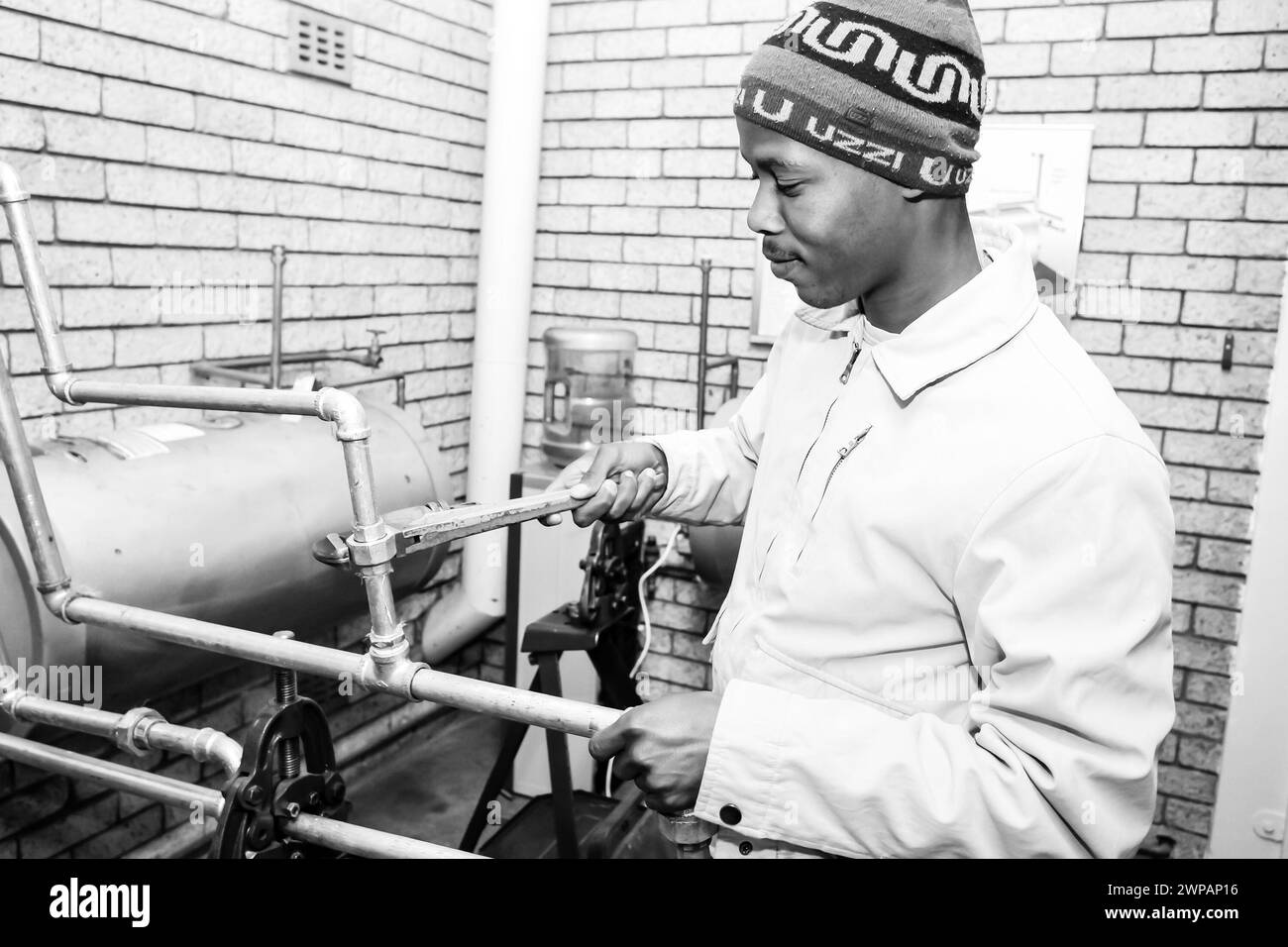Man smoking a large pipe near a brick wall Stock Photo - Alamy