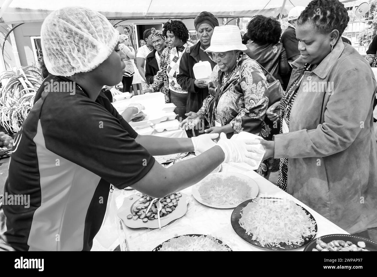 A group of women enjoying an outdoor buffet spread Stock Photo - Alamy
