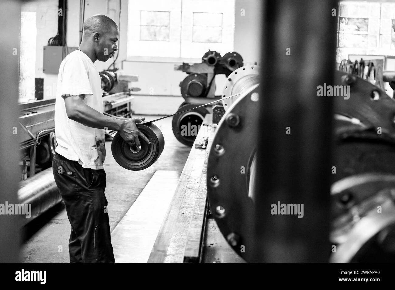 Man surrounded by multiple motorcycles in a factory garage Stock Photo ...