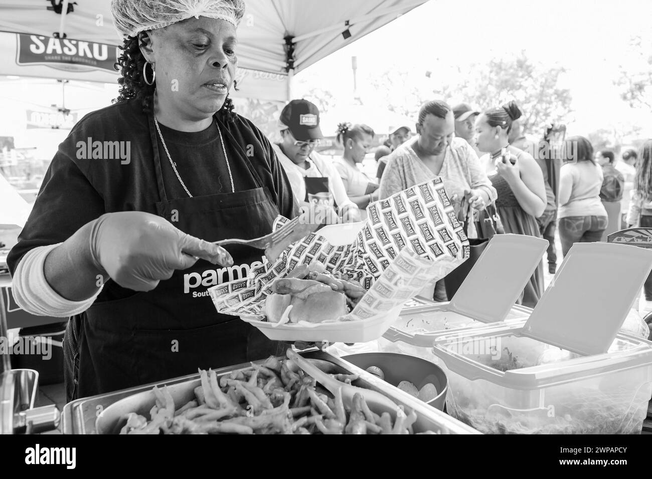 A woman cooking among market vendors Stock Photo - Alamy