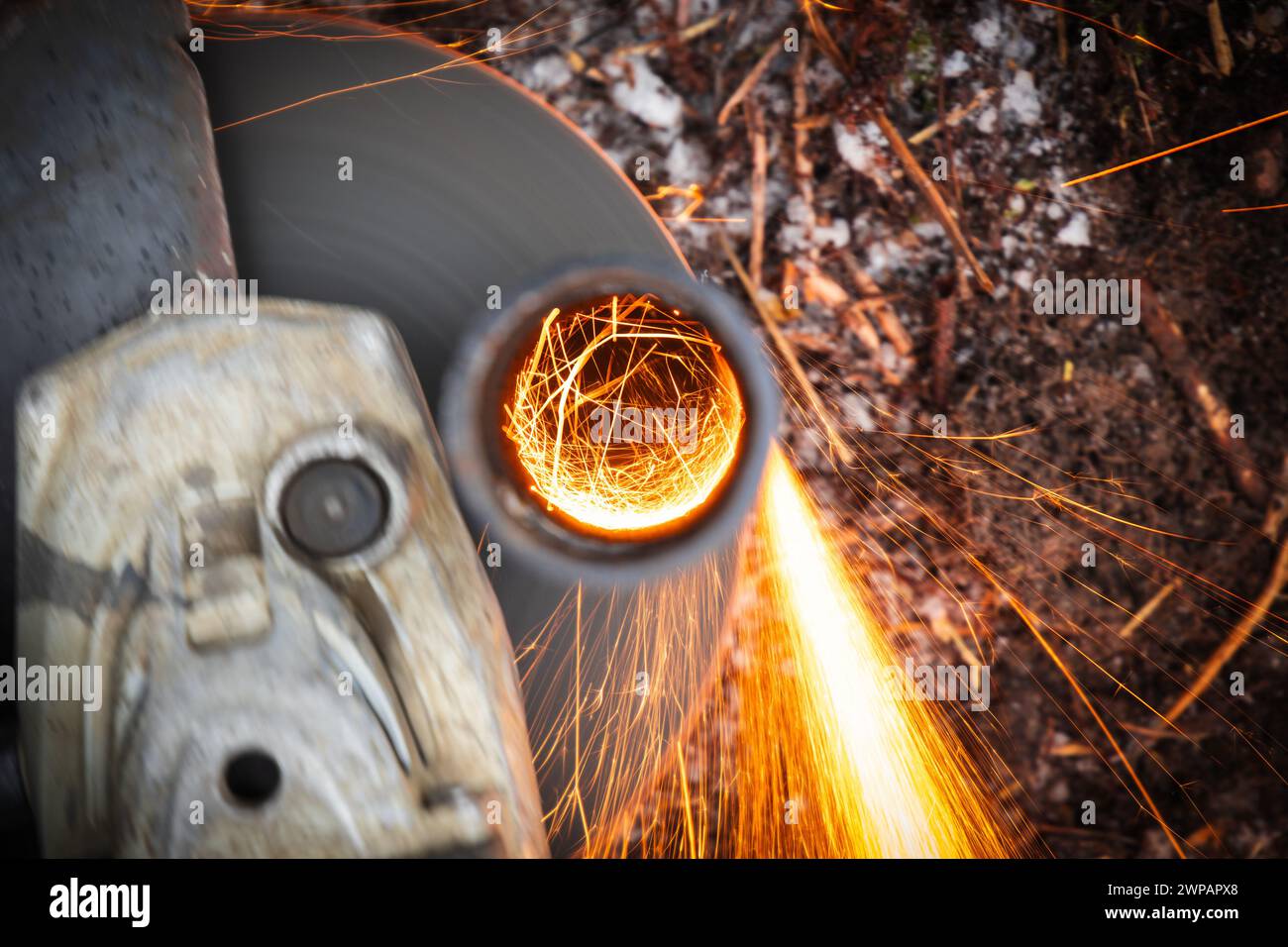 Angle grinder radial machine cutting steel tube with bright sparks ...