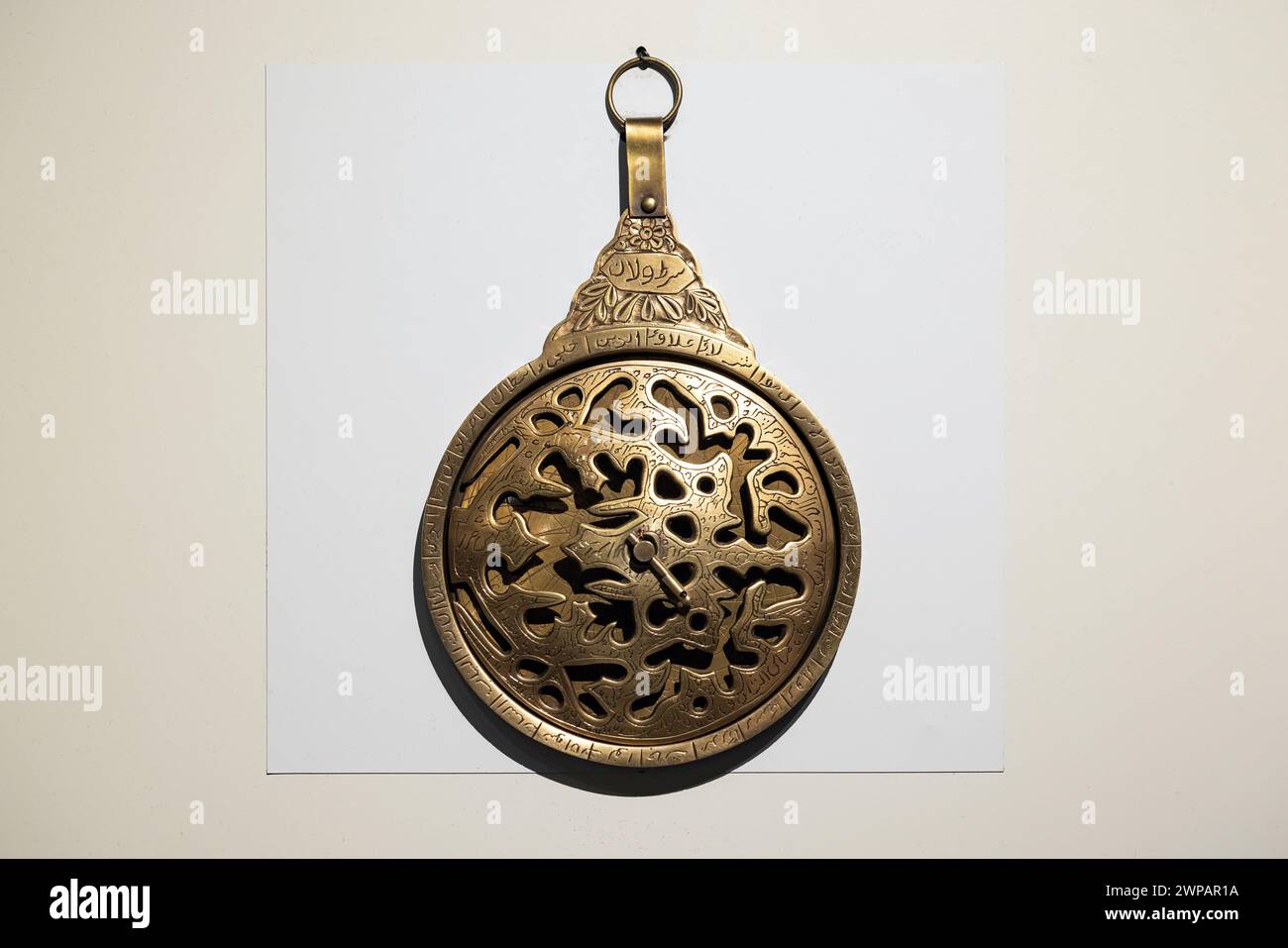 Antique Arabian astrolabe 18th-century is on white background. An ...
